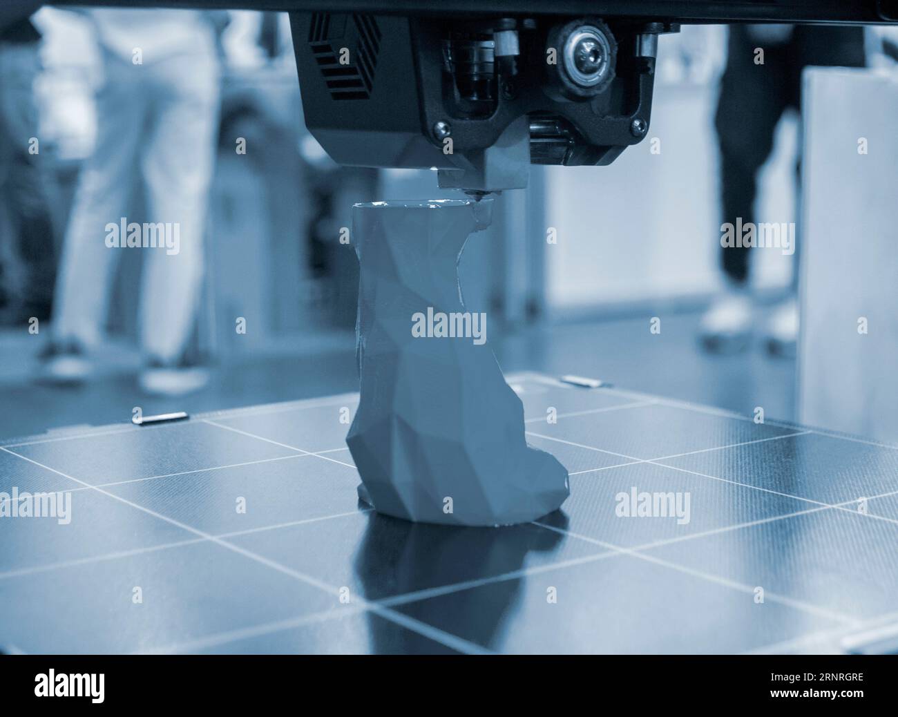 3D printer printing prototype of toy from molten plastic. Process of ...