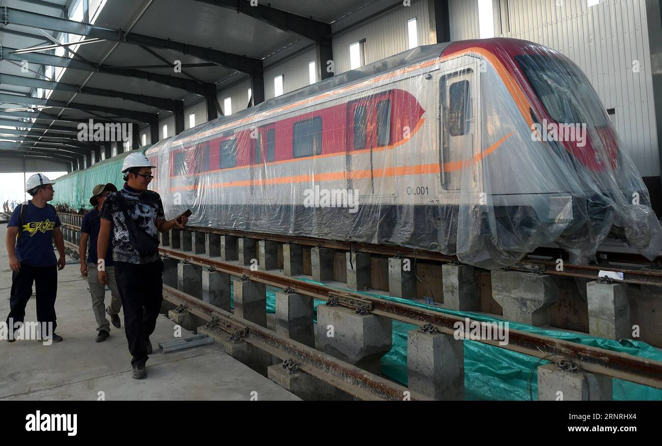 (171003) -- LAHORE, Oct. 3, 2017 -- Engineers walk past an engine of ...