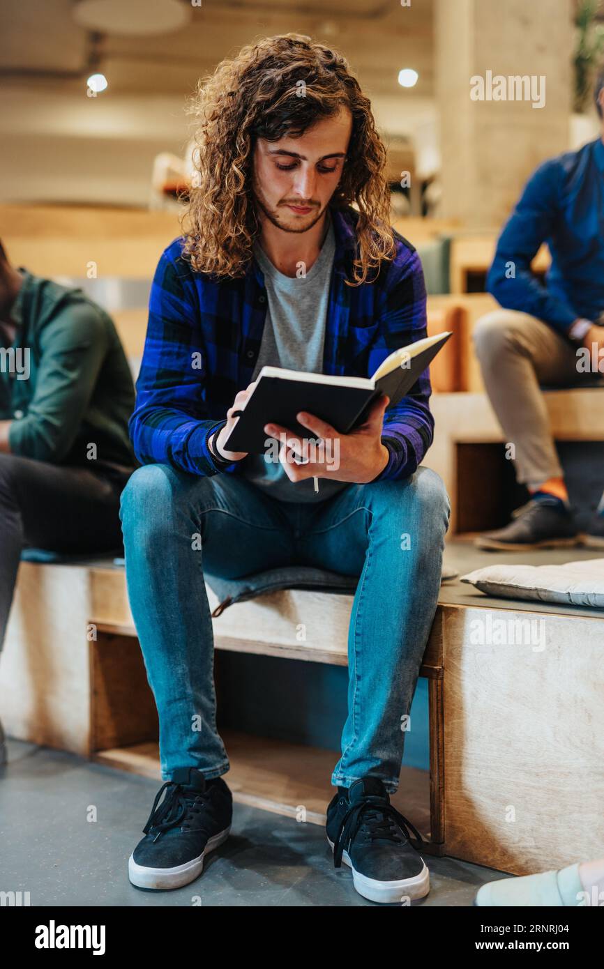 Read before you do! Male employee reading instructions for his daily ...