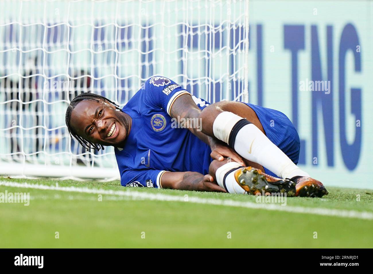 Chelsea's Raheem Sterling holding his leg during the Premier League ...
