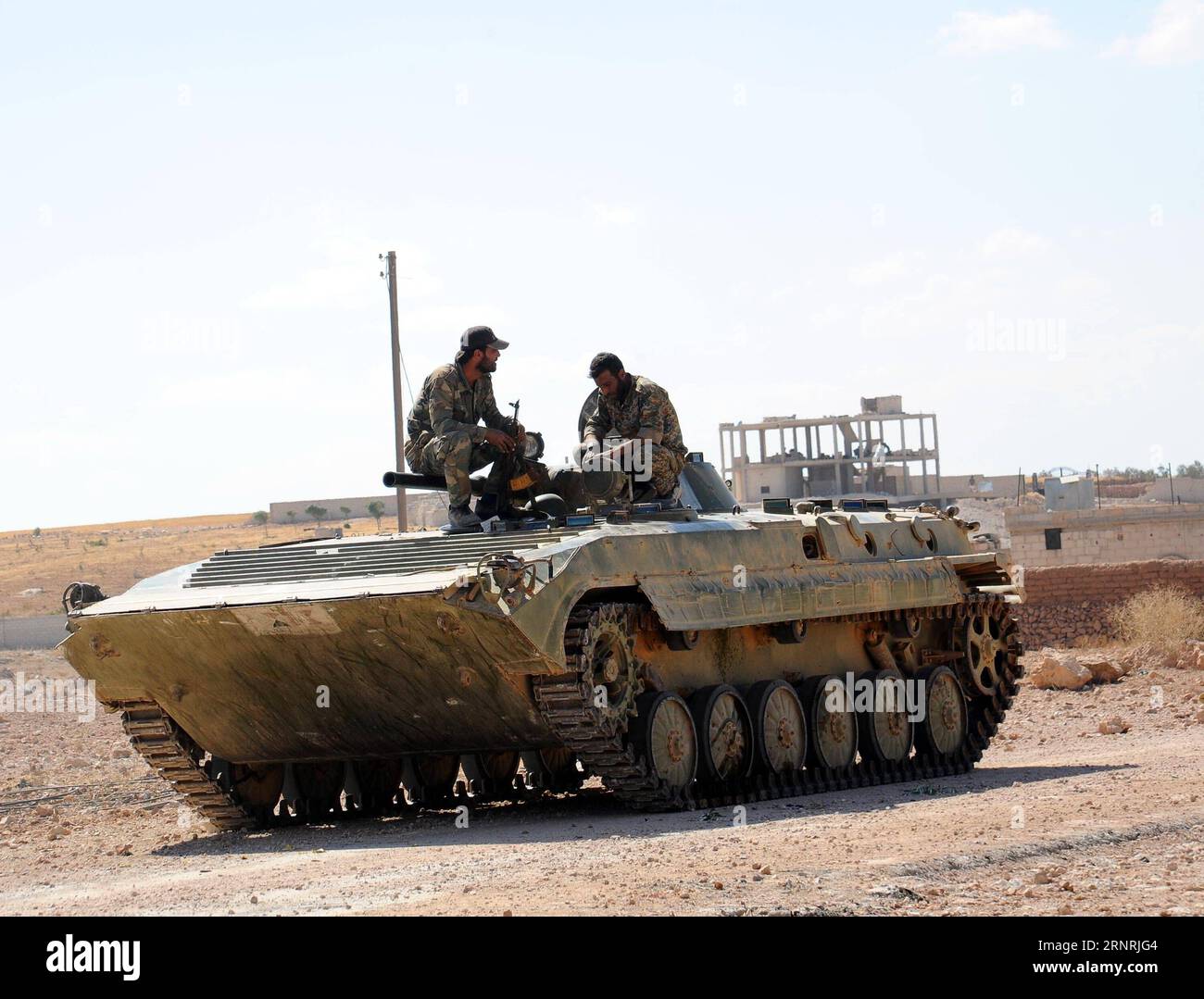 (171003) -- HAMA (SYRIA), Oct. 3, 2017 -- Syrian soldiers are seen atop ...