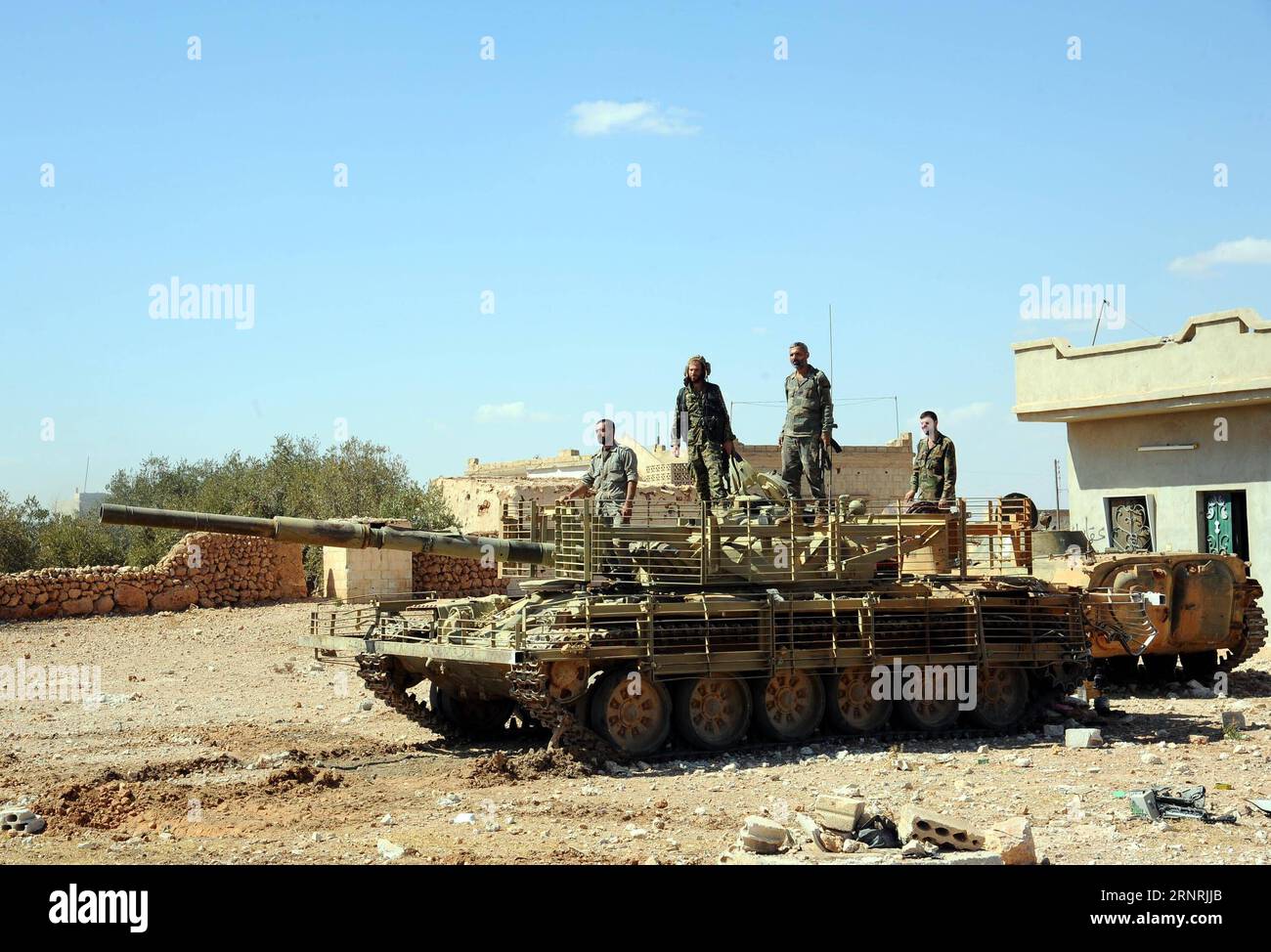 (171003) -- HAMA (SYRIA), Oct. 3, 2017 -- Syrian soldiers stand on an ...