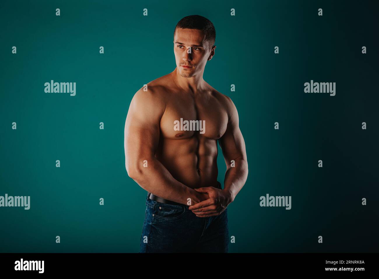 Aesthetic man standing in front of a green background and posing Stock ...