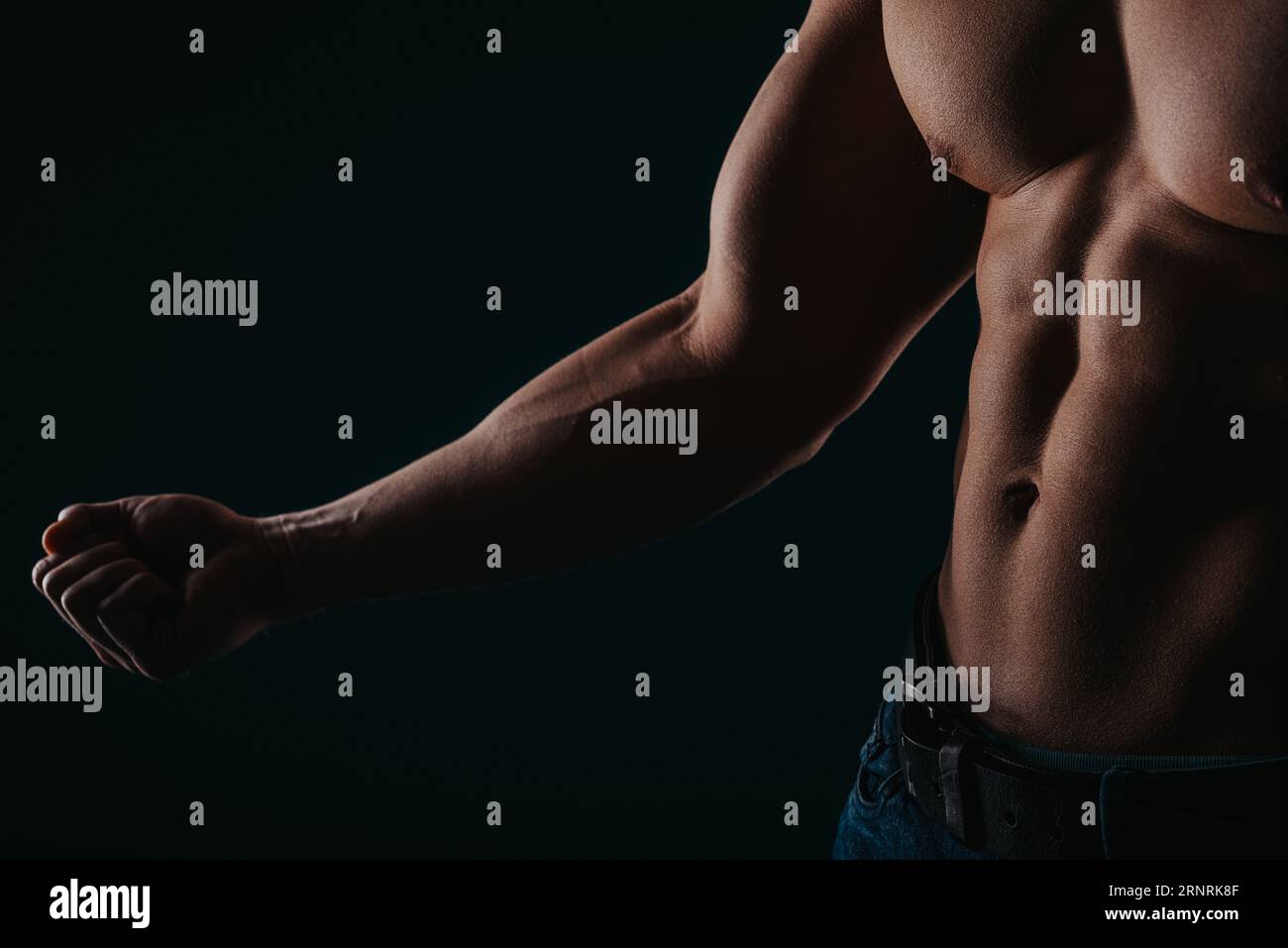 Fit, strong man showing his abs. and right hand biceps. Clear ...