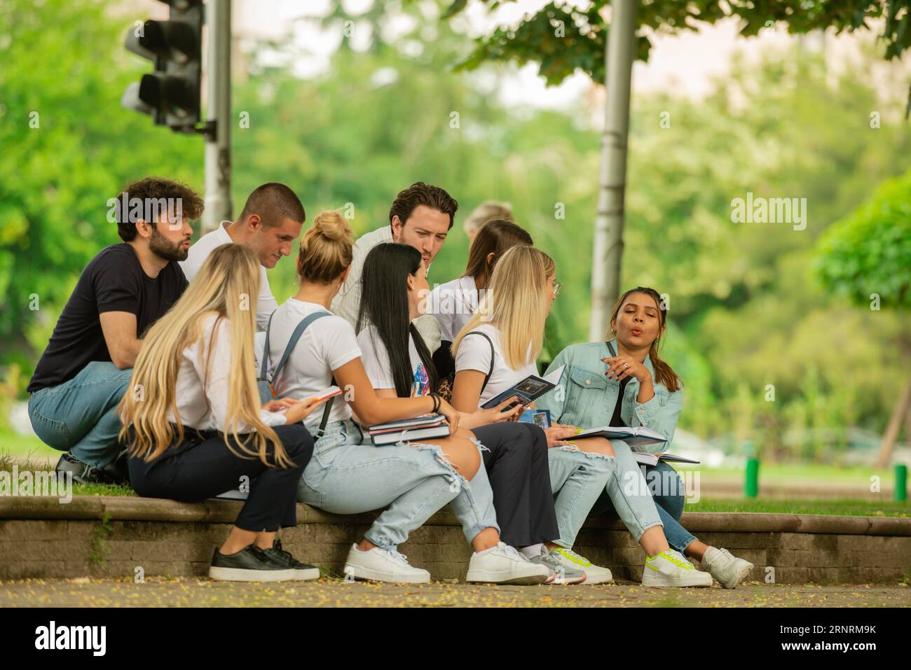 Multiracial young group of university or high school students sitting ...