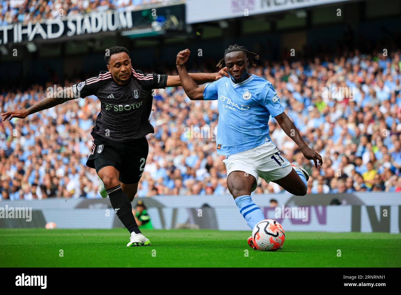 Jeremy Doku #11 of Manchester City and Kenny Tete #2 of Fulham ...