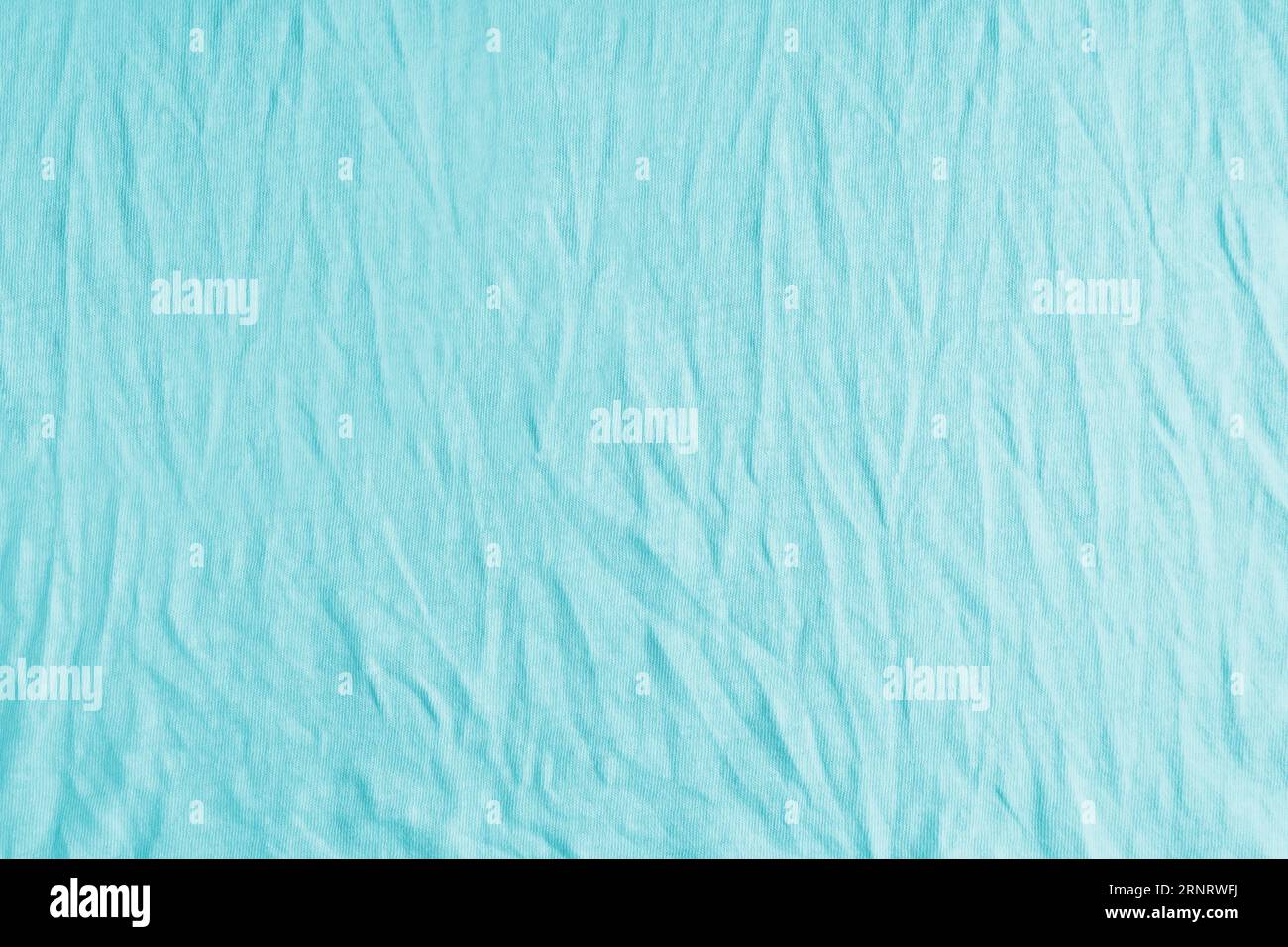 Wrinkled, crumpled cyan fabric texture background. Wrinkled and creased ...