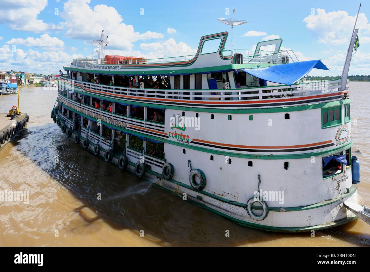 Traditional wooden boat docking on the pier of Nova Olinda do Norte ...