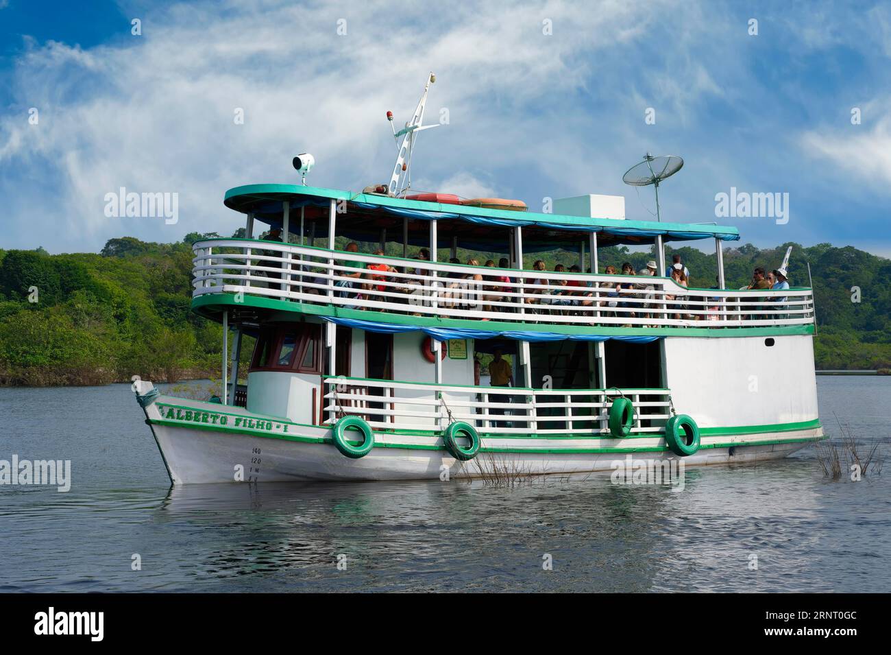 Traditional Amazonian wooden boat navigating on the Rio Negro, Manaus ...