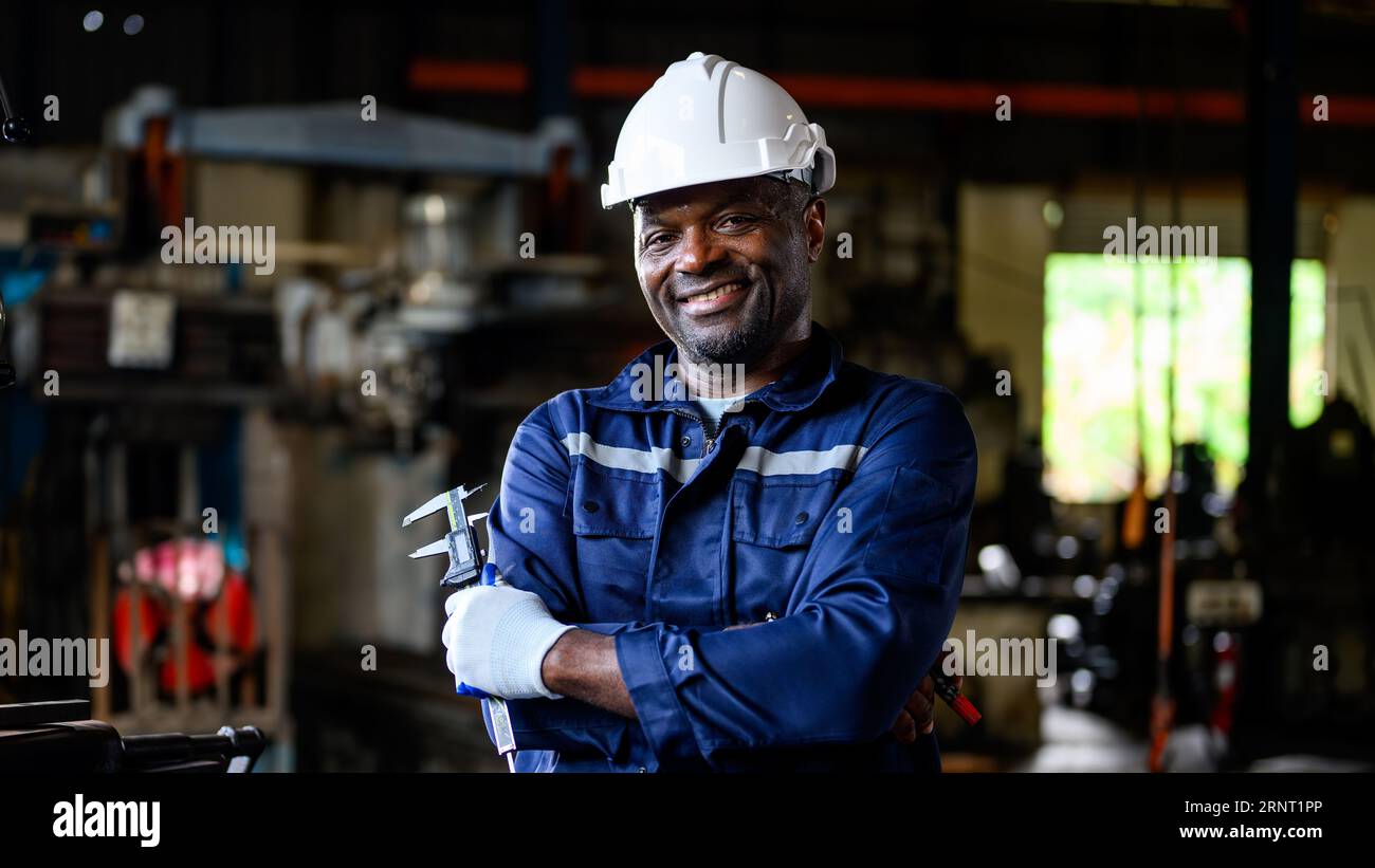 Mechanical engineer with safety hat checking and inspecting machine ...