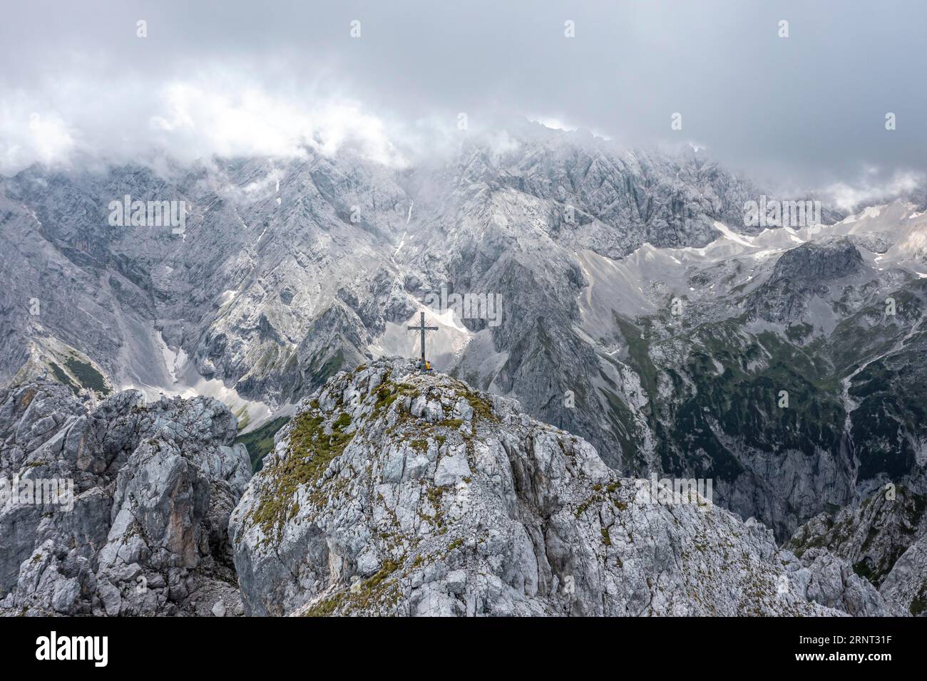 Summit cross of the Waxenstein, Wetterstein Mountains at the back ...