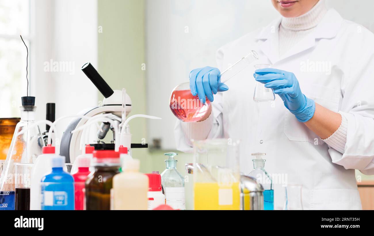 Close up scientist holding flask Stock Photo - Alamy