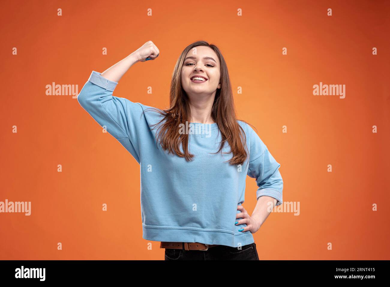 Front view strong woman with bicep Stock Photo - Alamy