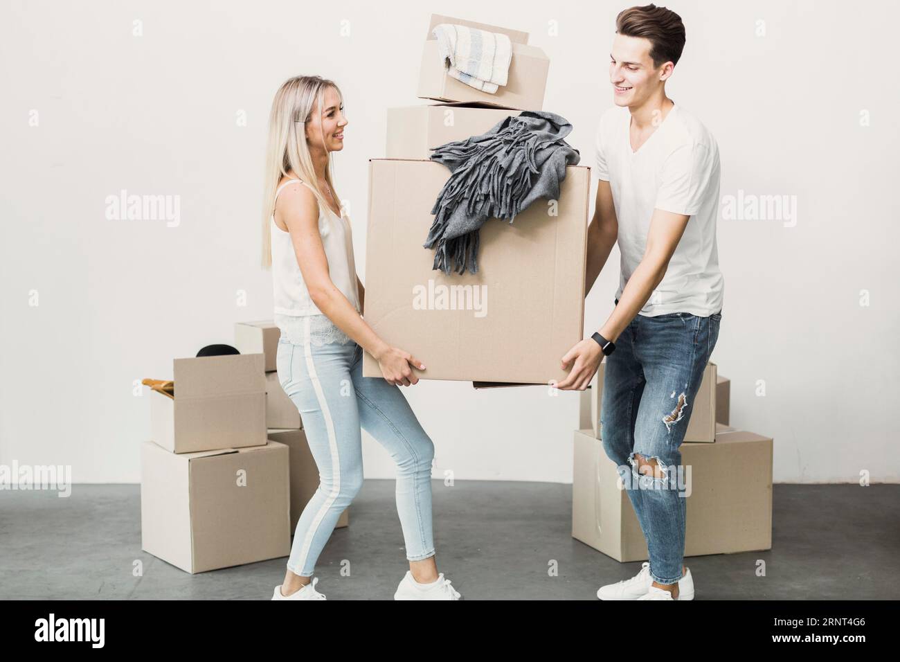Woman carrying heavy box hi-res stock photography and images - Alamy