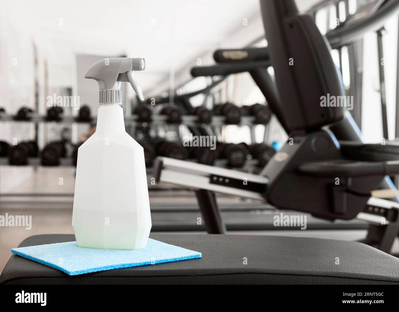 Bottle cleaning solution gym bench Stock Photo - Alamy