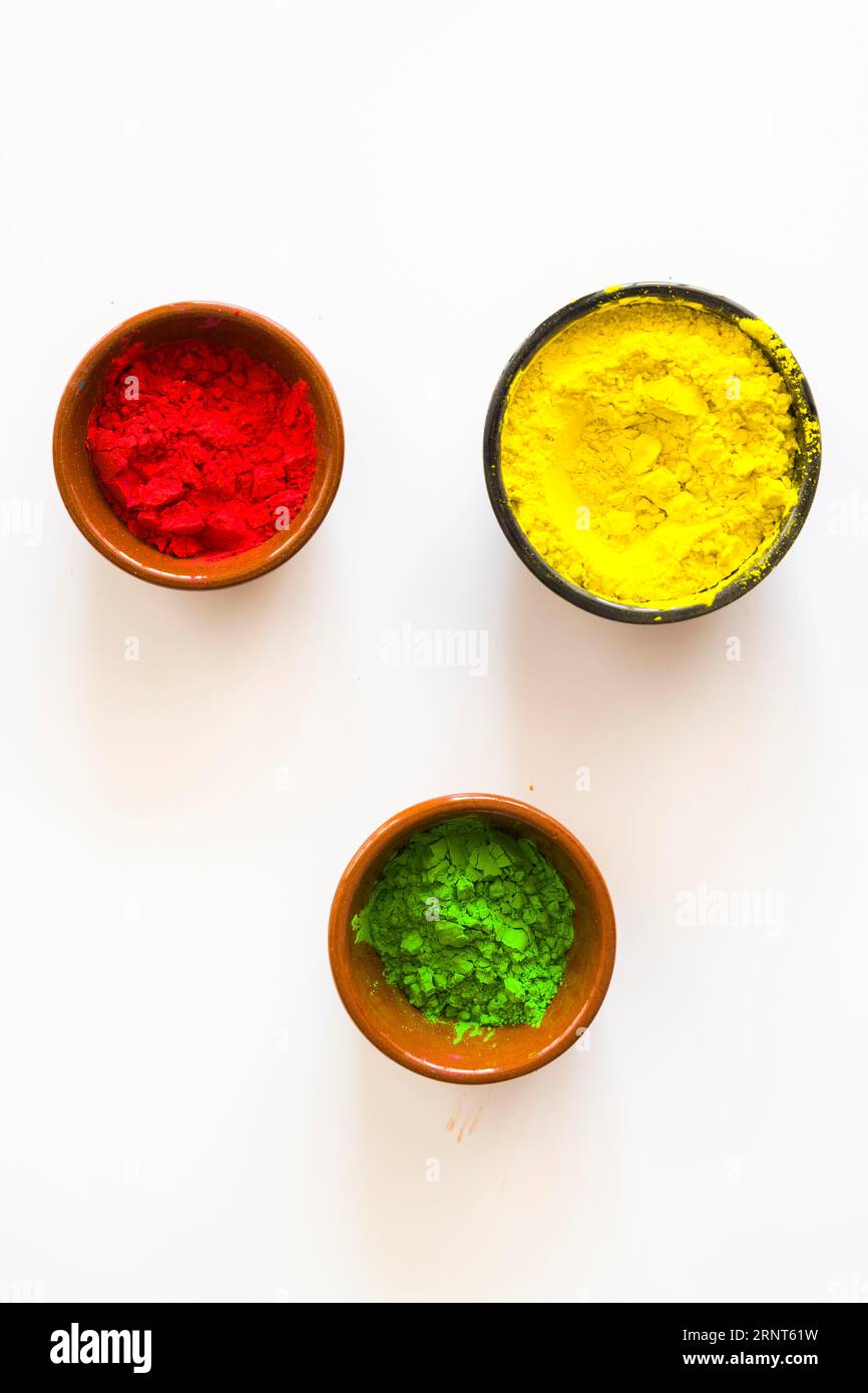 Red yellow green holi color powder bowls white background Stock Photo ...