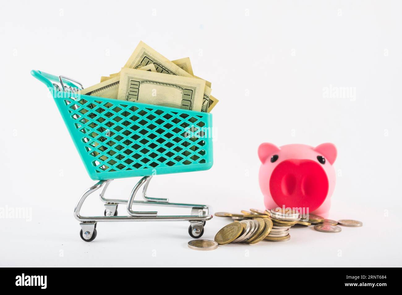 Small grocery cart with money piggy bank Stock Photo - Alamy
