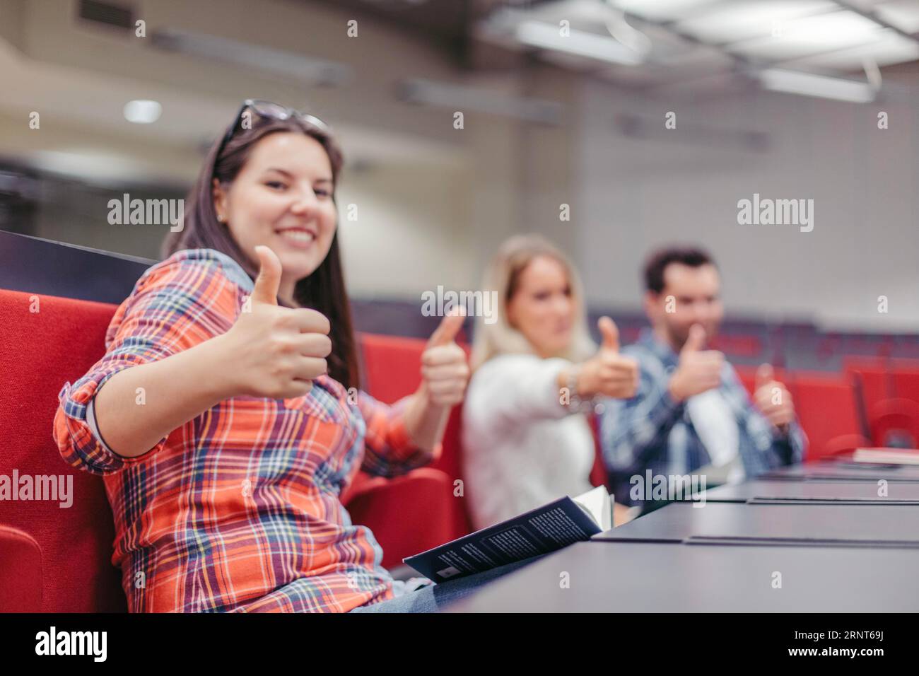 Students making thumbs up during break Stock Photo - Alamy