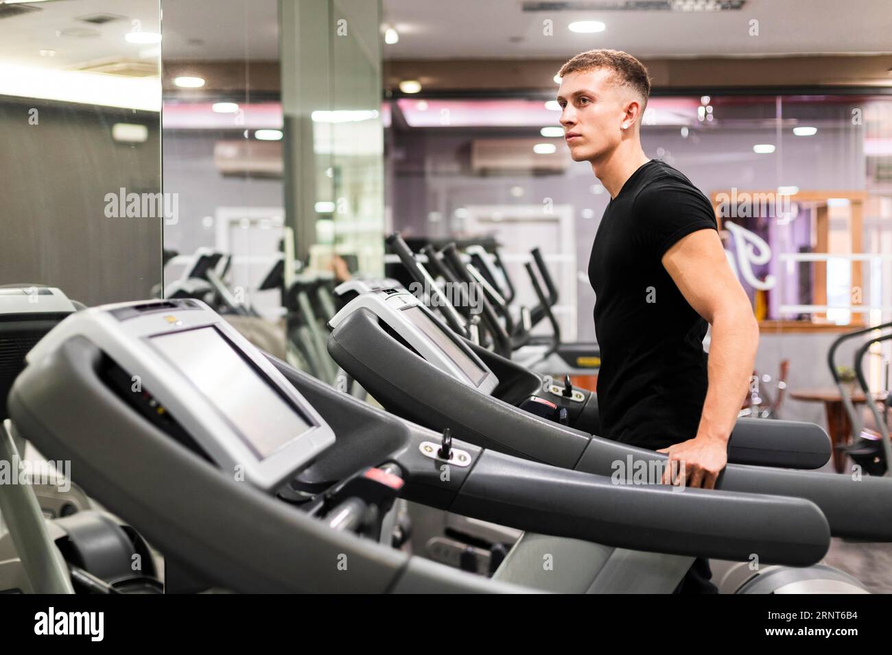 Side view man gym treadmill Stock Photo - Alamy