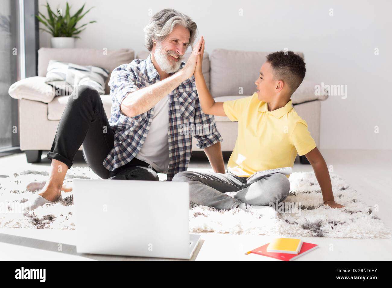 Teacher student high fiving Stock Photo - Alamy
