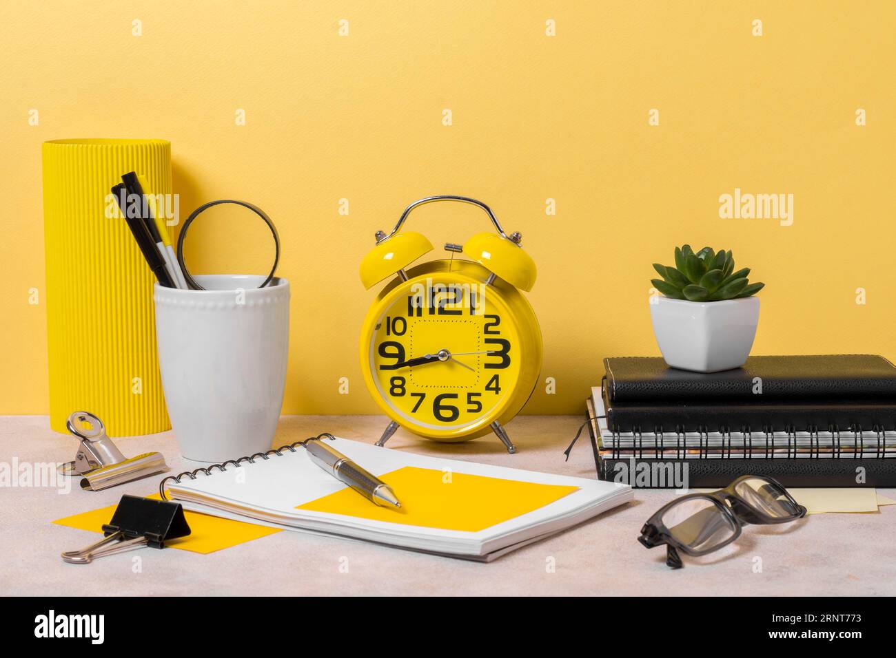Workspace arrangement with clock Stock Photo - Alamy