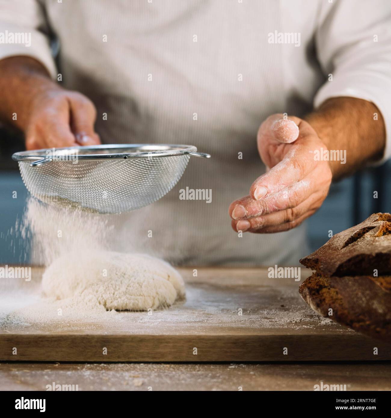 Baker sifting wheat flour through steel sieve knead dough Stock Photo ...