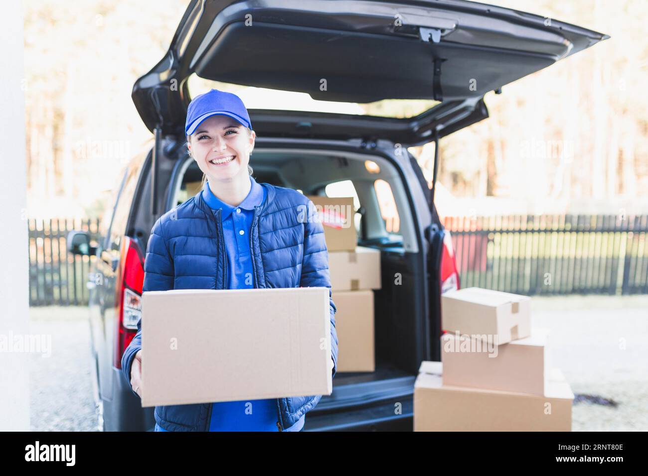 Cheerful girl with carton boxes Stock Photo - Alamy