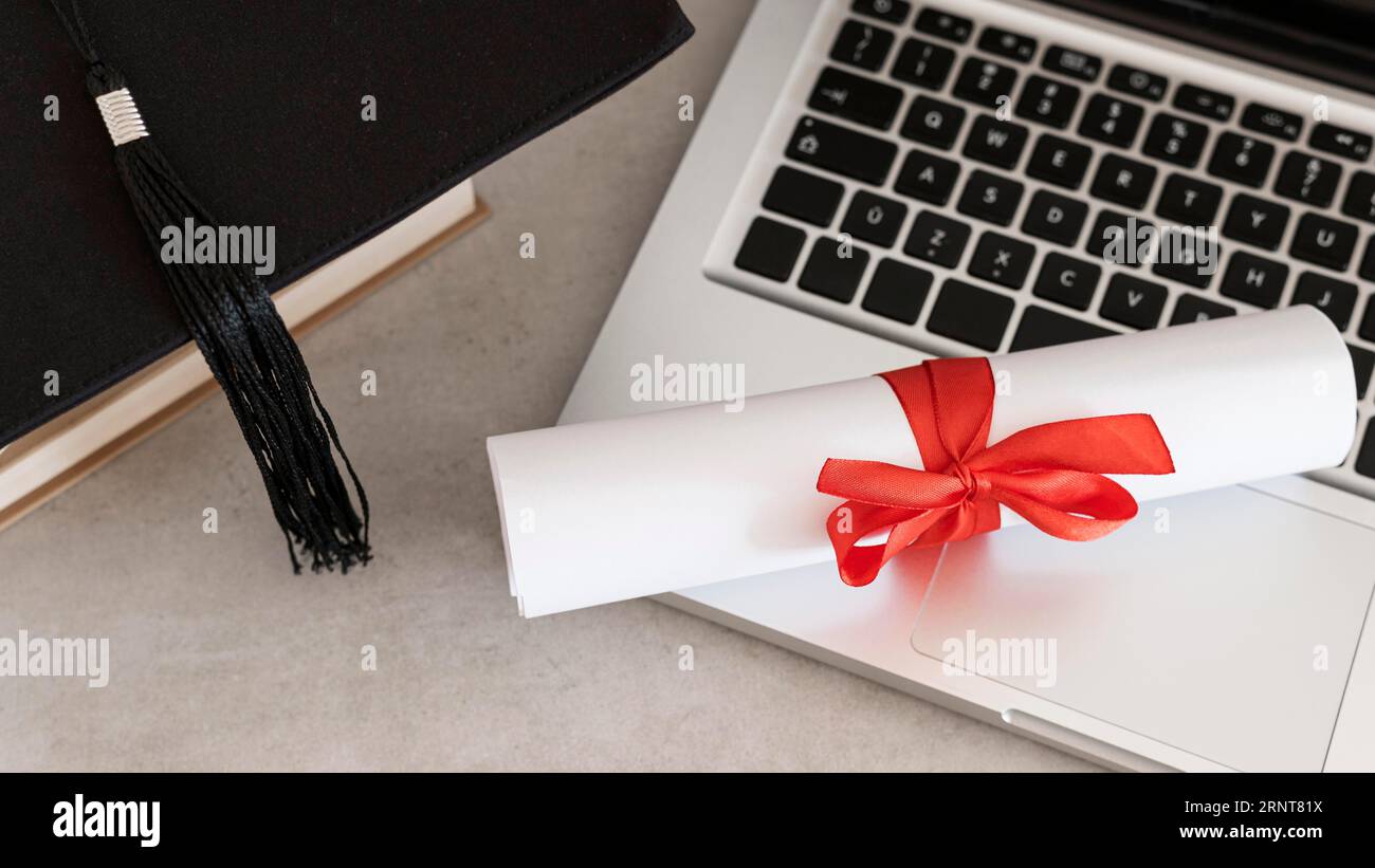Certificate with ribbon bow laptop Stock Photo - Alamy