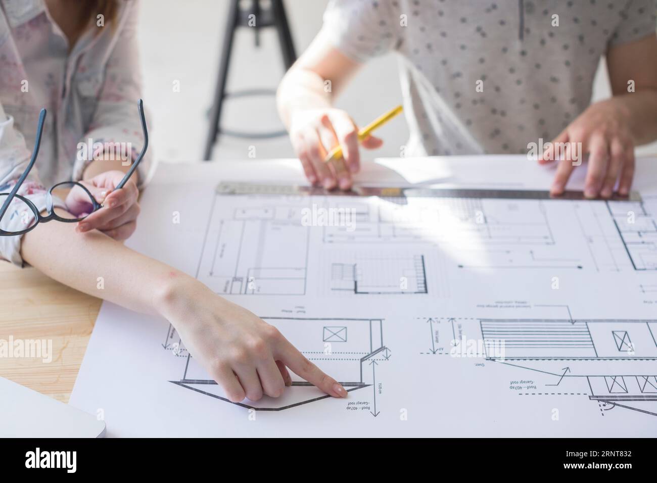 Close up female hand pointing blueprint table workplace Stock Photo - Alamy