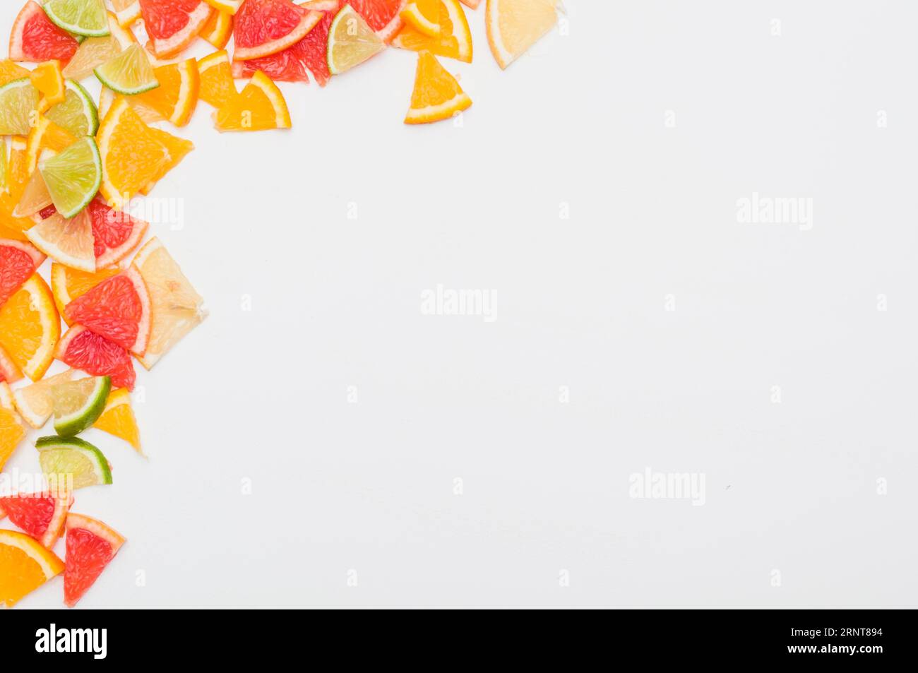 Colorful citrus fruit slices corner white background Stock Photo - Alamy