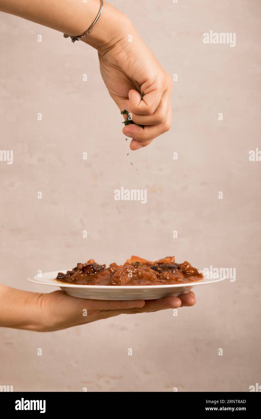 Hand garnishing dish hi-res stock photography and images - Alamy