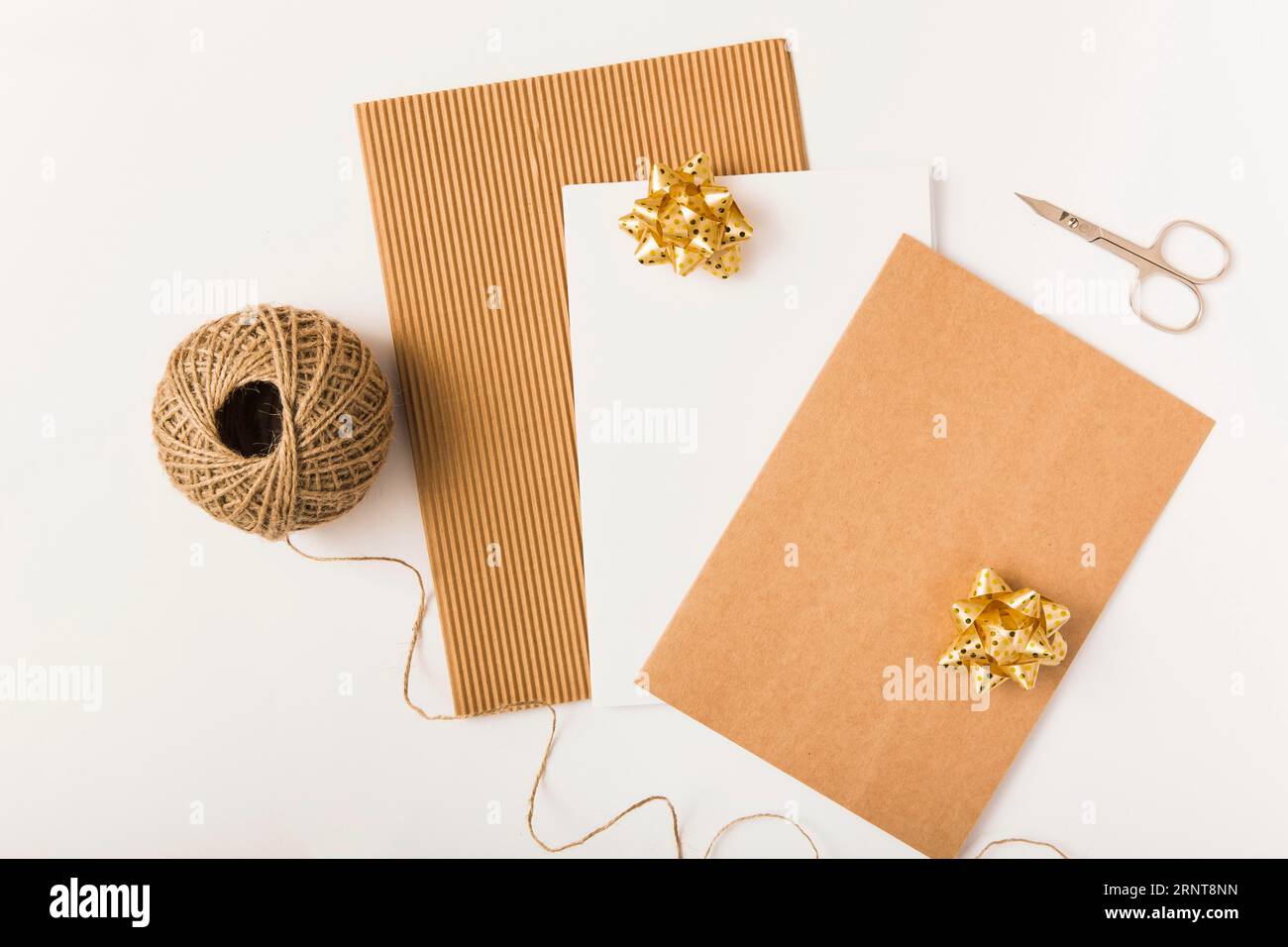 Craft wrapping paper with golden bows white background Stock Photo - Alamy