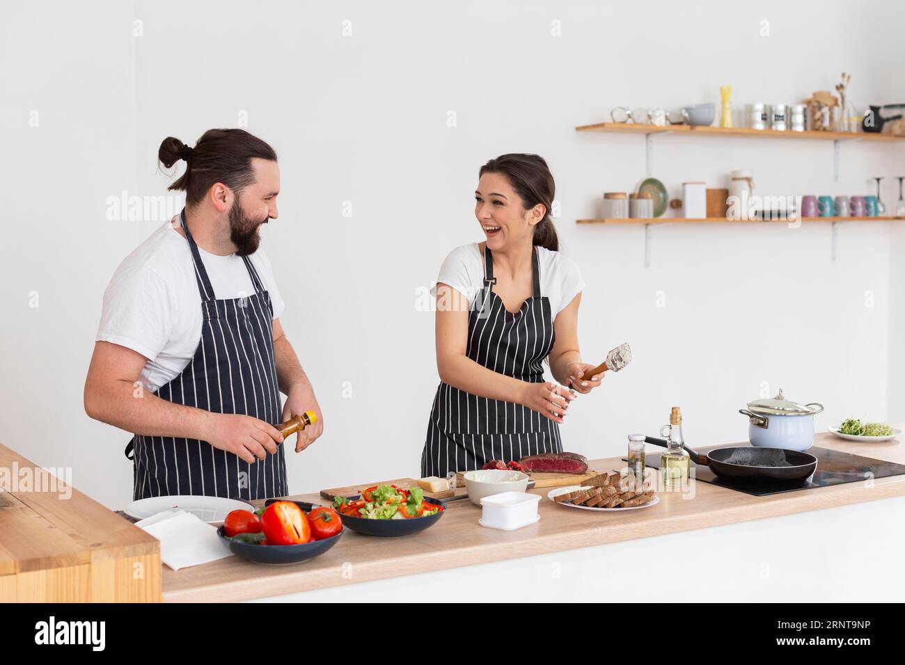 Happy friends cooking together Stock Photo - Alamy