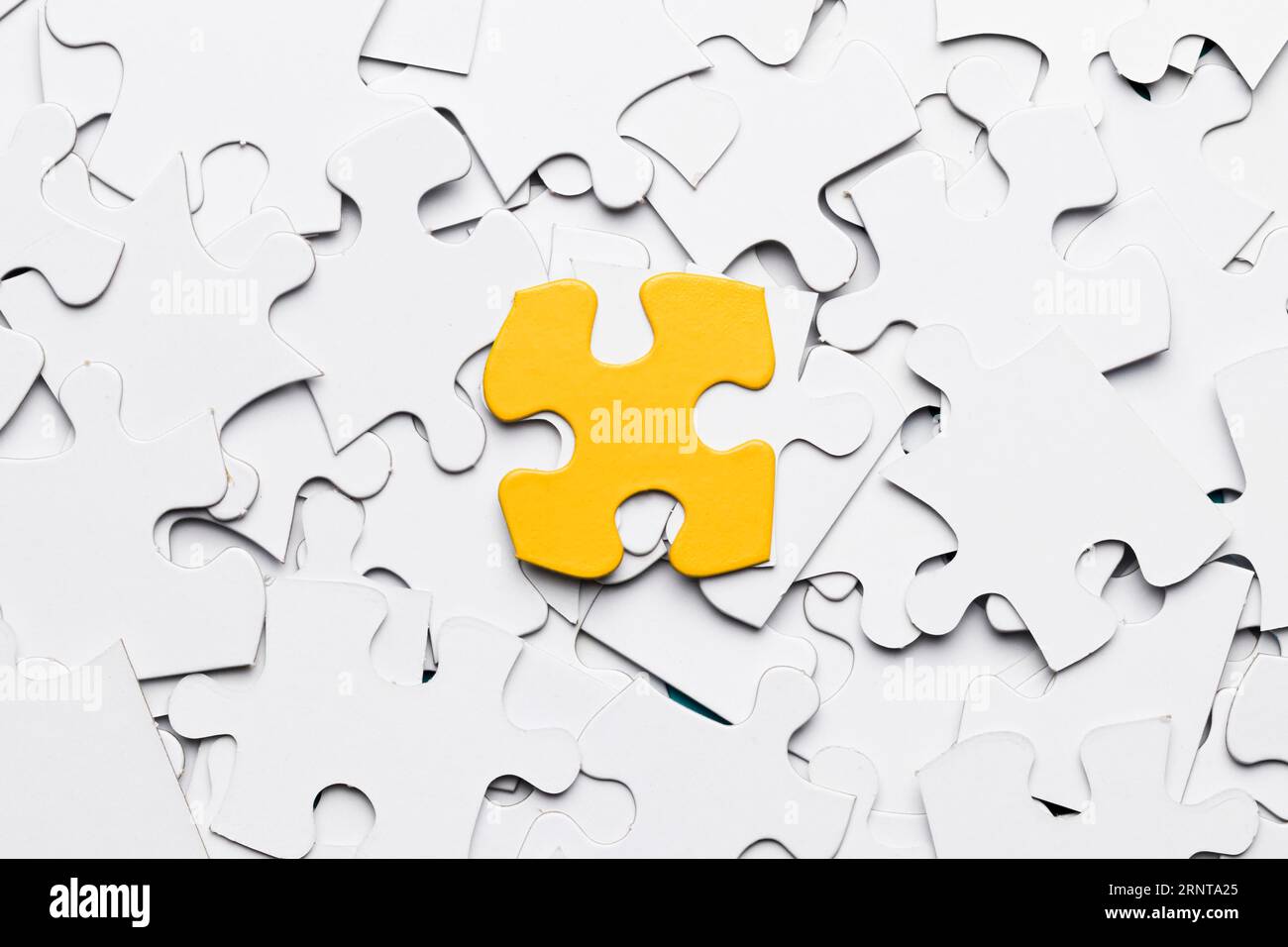 High angle view yellow puzzle piece white puzzle pieces Stock Photo - Alamy