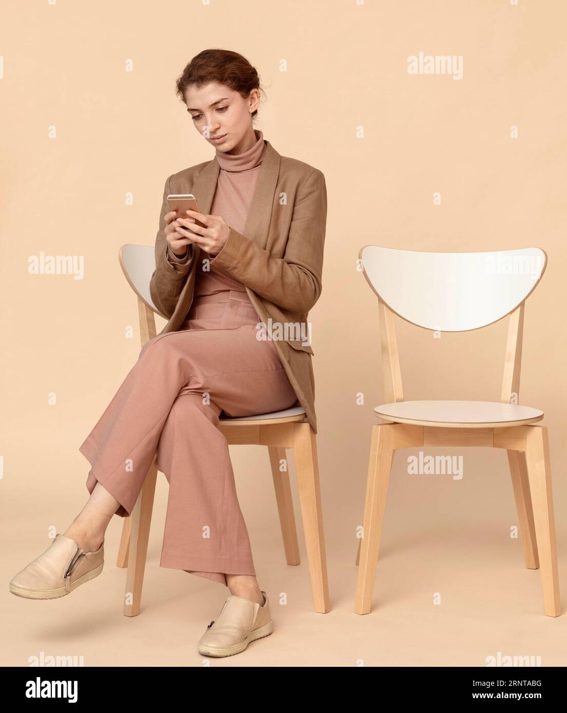 Model sitting empty chair Stock Photo - Alamy