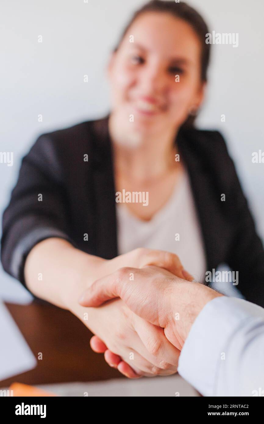 Office worker shaking hands Stock Photo - Alamy