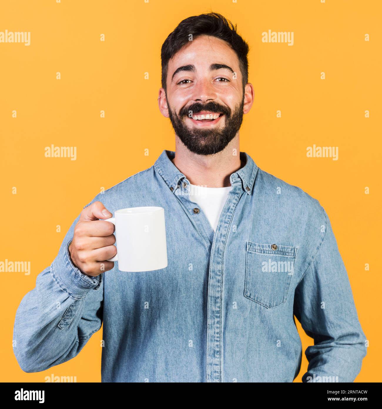 Medium shot smiley guy holding cup Stock Photo - Alamy