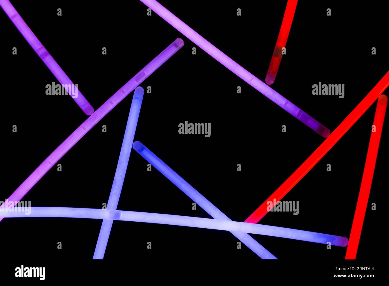 Purple blue red neon straws dark background Stock Photo - Alamy