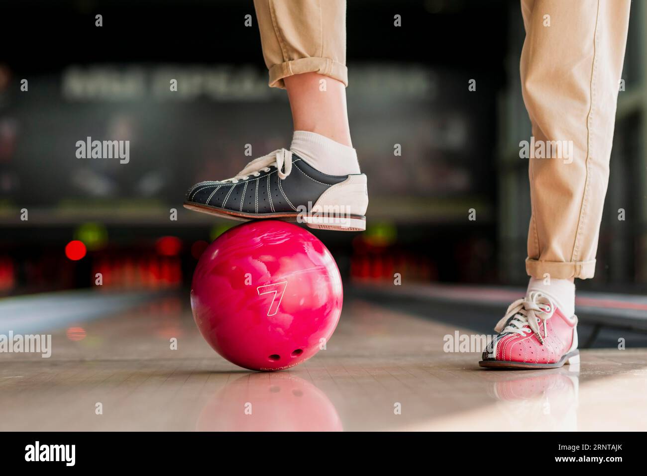 Person keeping with foot red bowling ball Stock Photo - Alamy