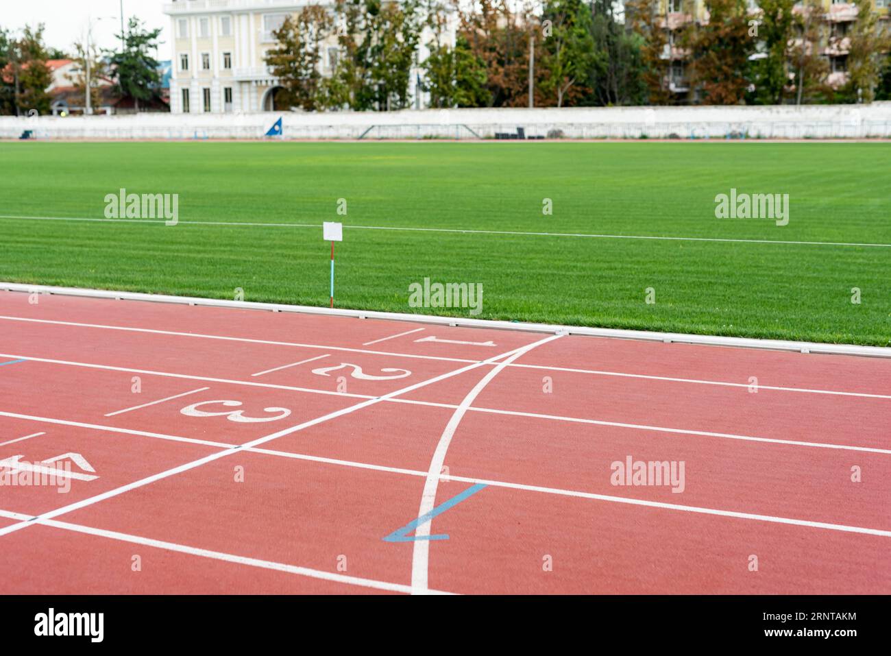Running track with grass field sunny day Stock Photo - Alamy