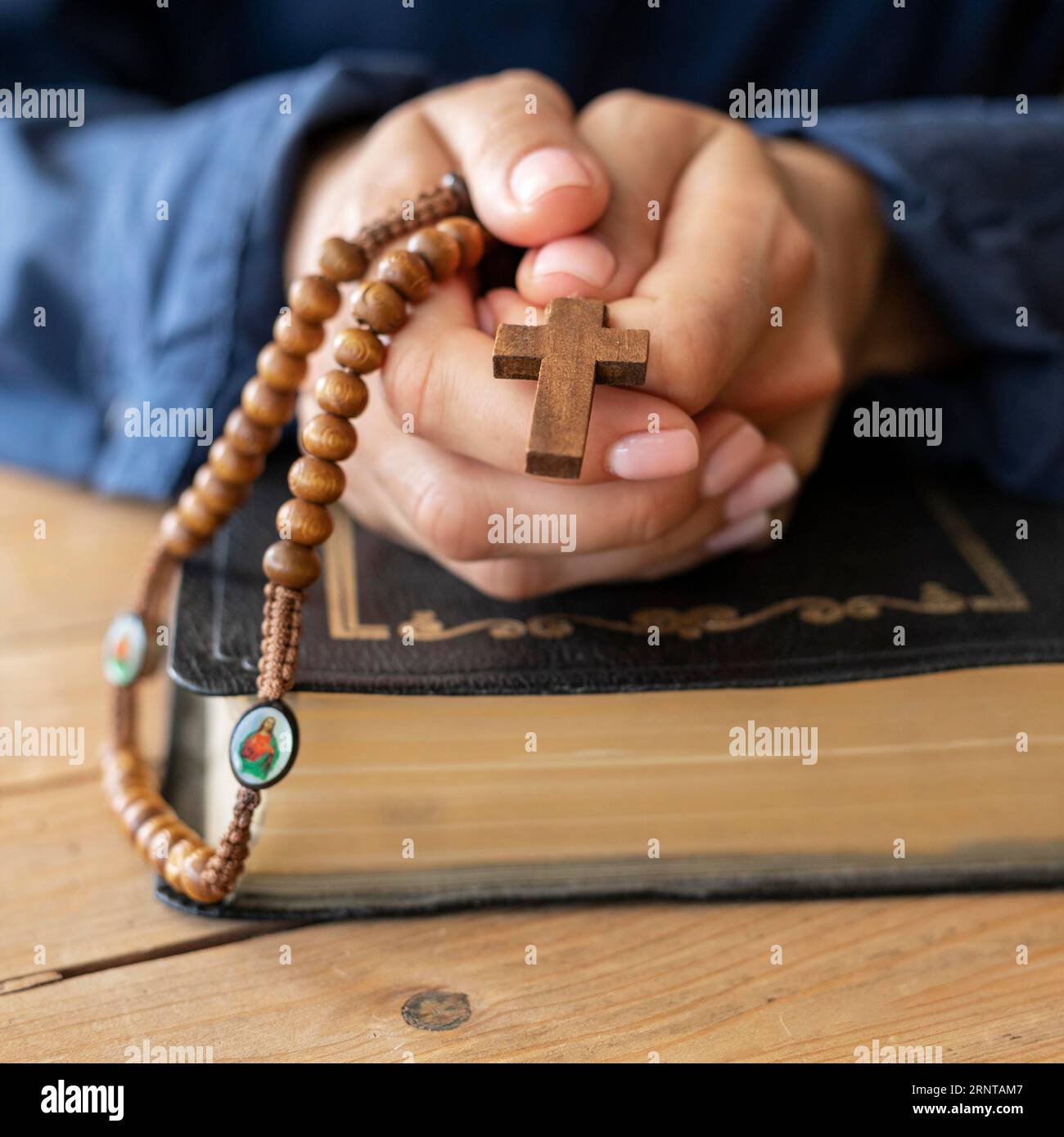 Person holding rosary hands praying Stock Photo - Alamy