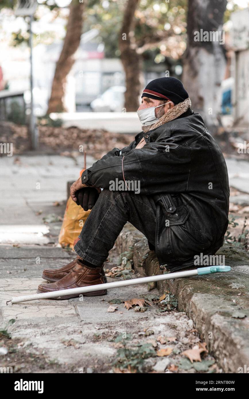 Side view homeless man outdoors with cane medical mask Stock Photo - Alamy
