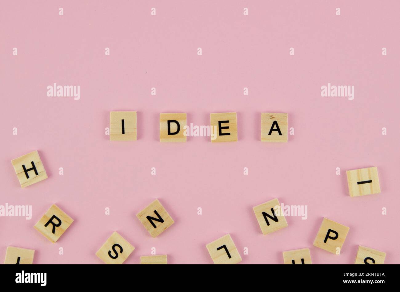 Scrabble letters idea word concept pink background Stock Photo - Alamy