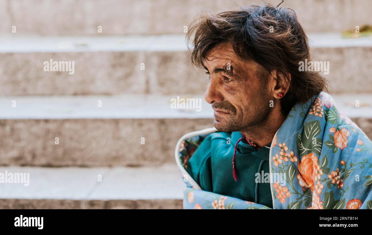 Side view homeless man outdoors with blanket stairs Stock Photo - Alamy