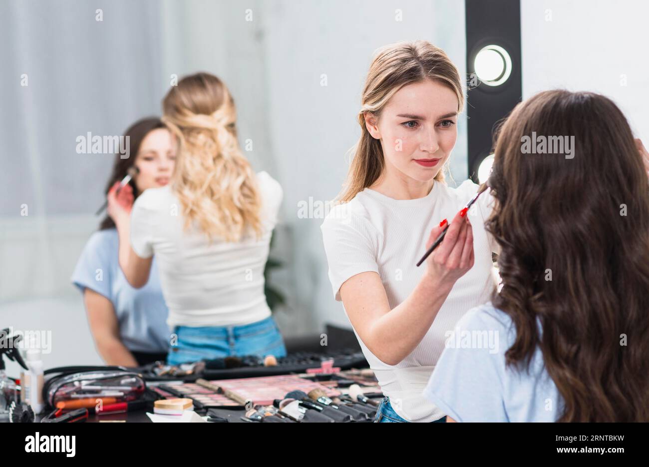 Visagiste creating professional makeup woman studio Stock Photo - Alamy
