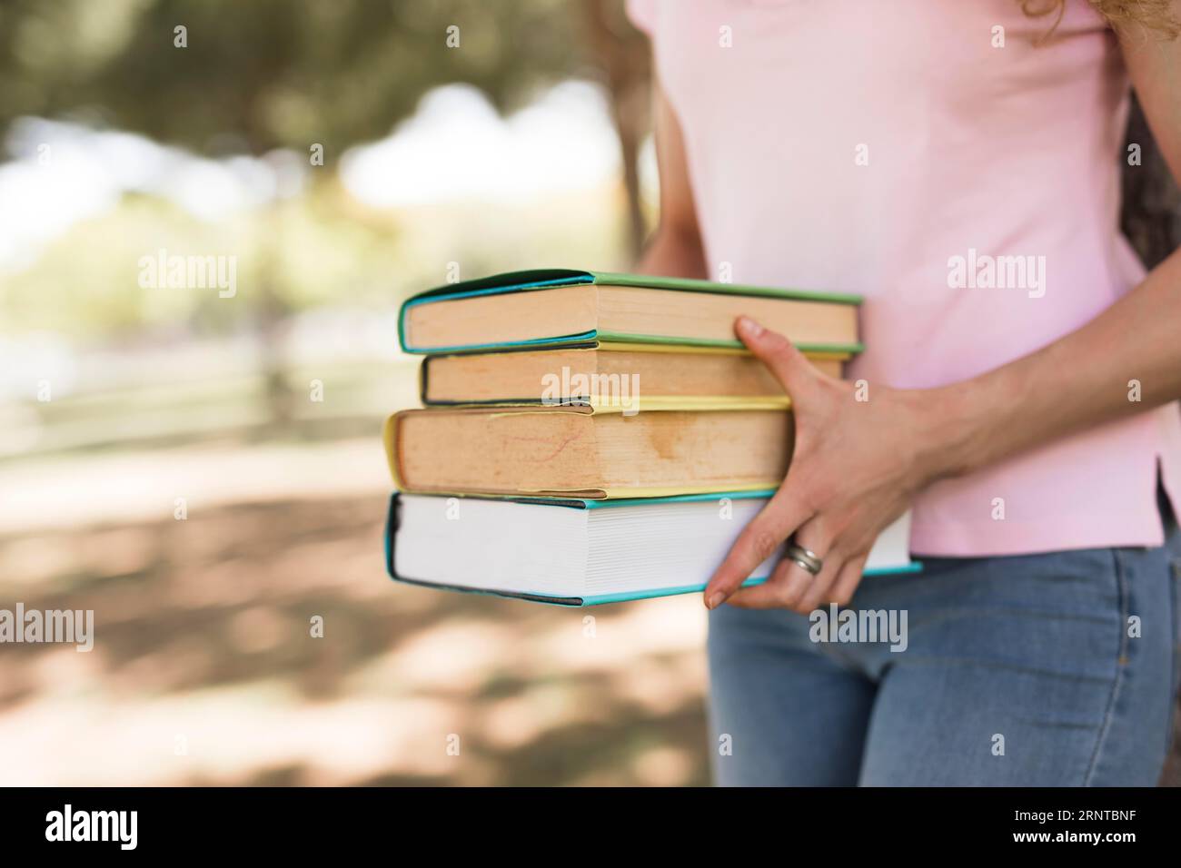 Female holding stack books hi-res stock photography and images - Alamy