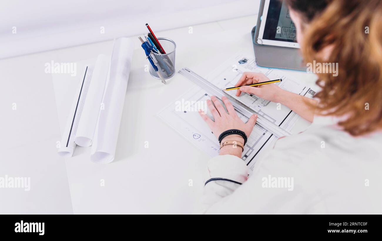 Anonymous woman developing blueprint Stock Photo - Alamy