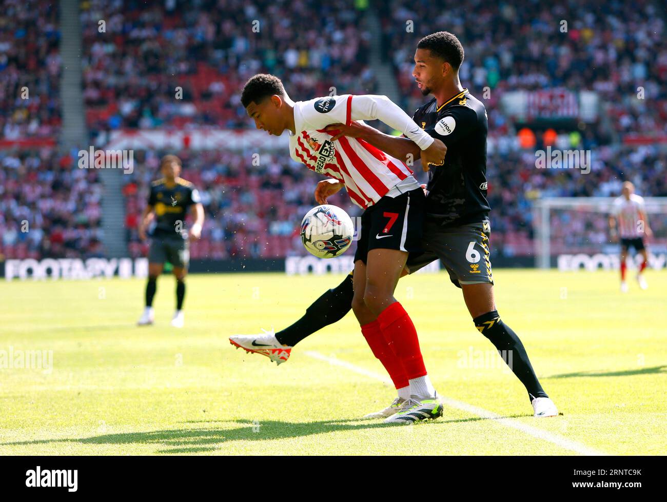 Sunderland's Jobe Bellingham (left) and Southampton's Mason Holgate ...