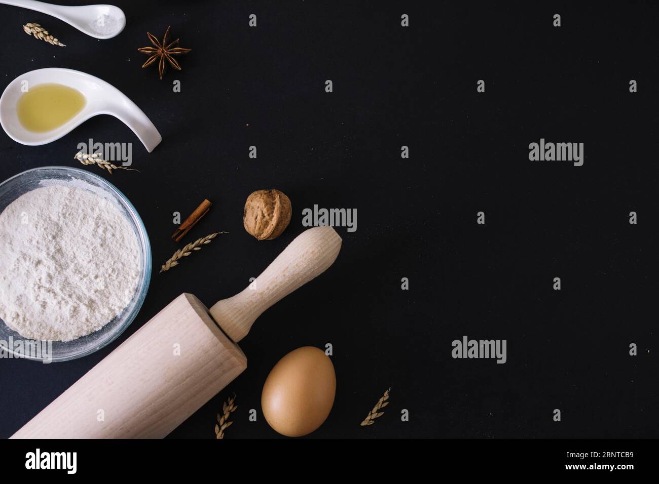Baking ingredients rolling pin black background Stock Photo - Alamy