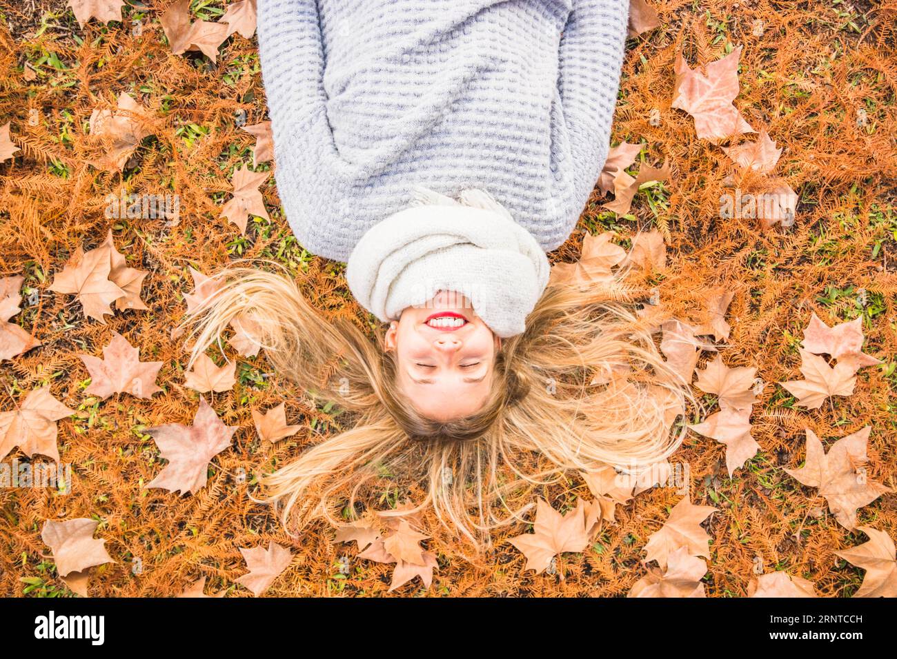 Beautiful female model laying autumn grass Stock Photo - Alamy